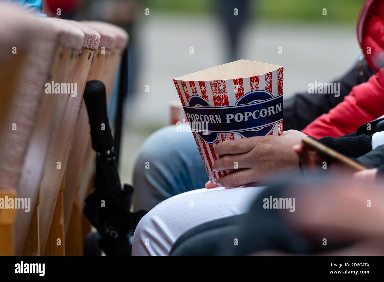 cinema audience watching movie and eating popcorn in the theatre, close ...