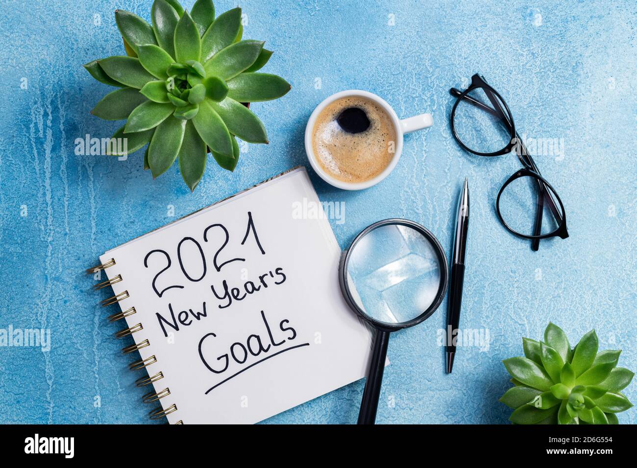 New year goals 2021 on desk. 2021 goals with notebook, coffee cup and ...