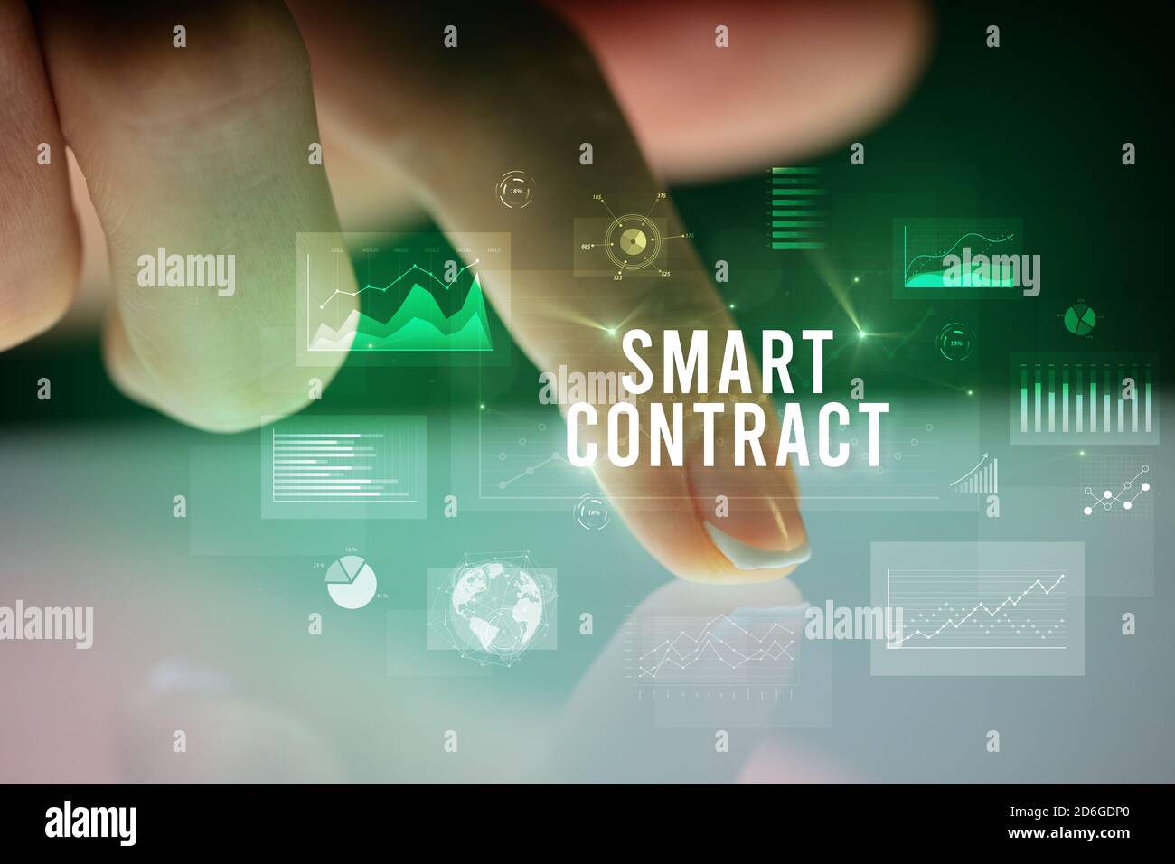 Finger touching tablet with charts and SMART CONTRACT inscription ...