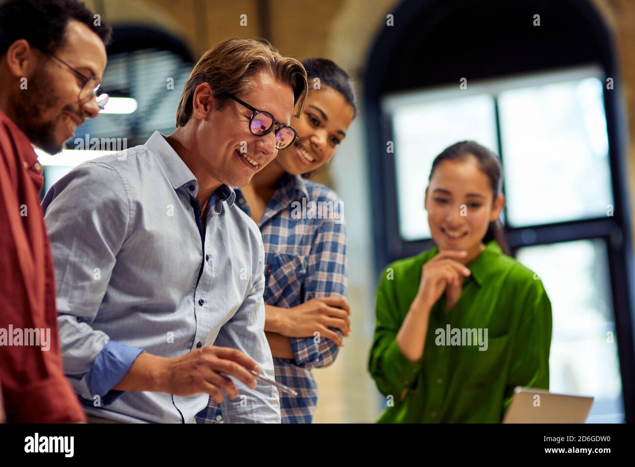 Positive male boss discussing project results and sharing ideas with ...