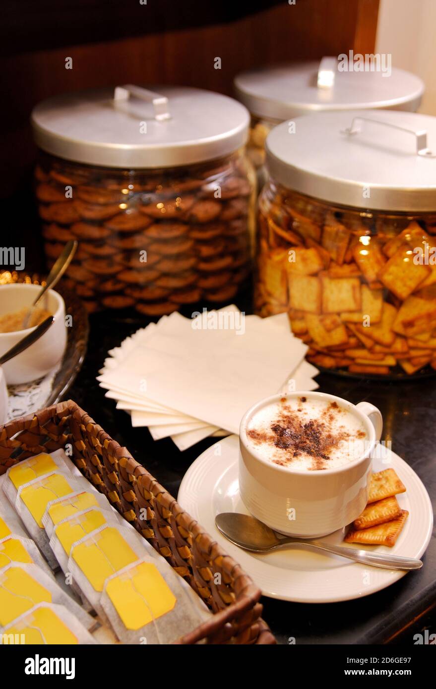 Coffee, tea bags and jar full of biscuits Stock Photo - Alamy