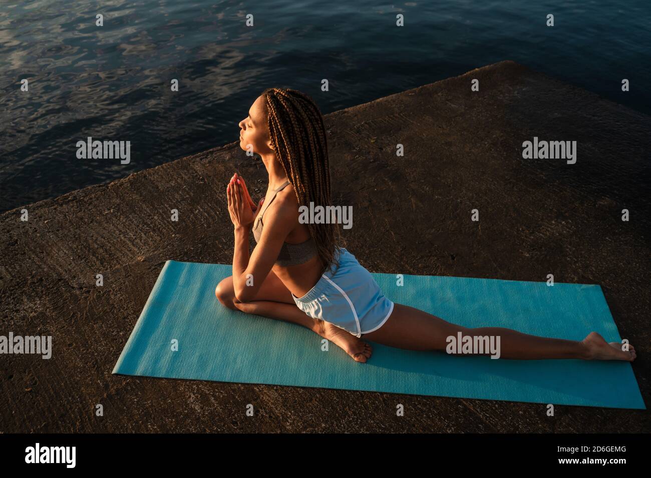 Image of focused african american girl in sportswear doing yoga ...