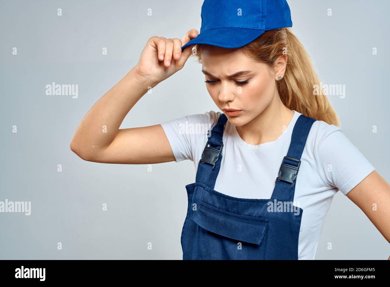 woman in work uniform blue cap service delivery service light ...
