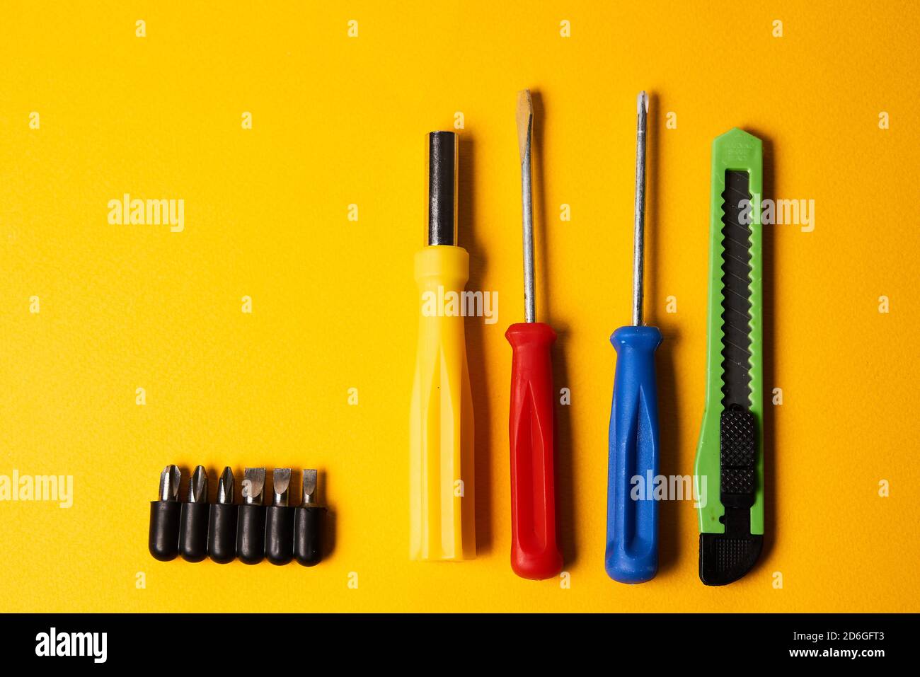 screwdrivers and construction tools on yellow background equipment for ...