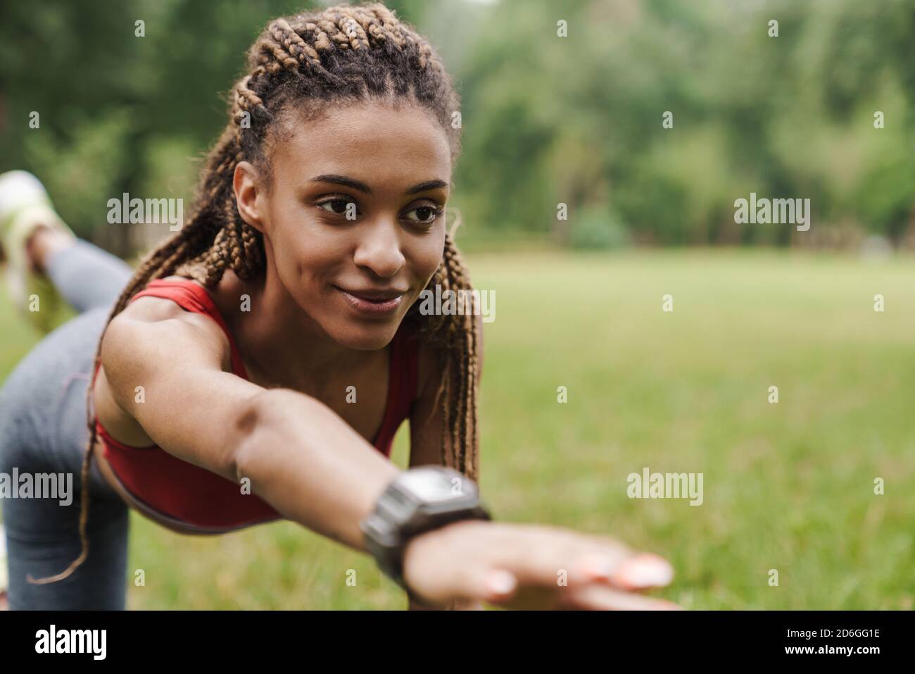 Beautiful younf african sport girl doing yoga exercises in the park ...