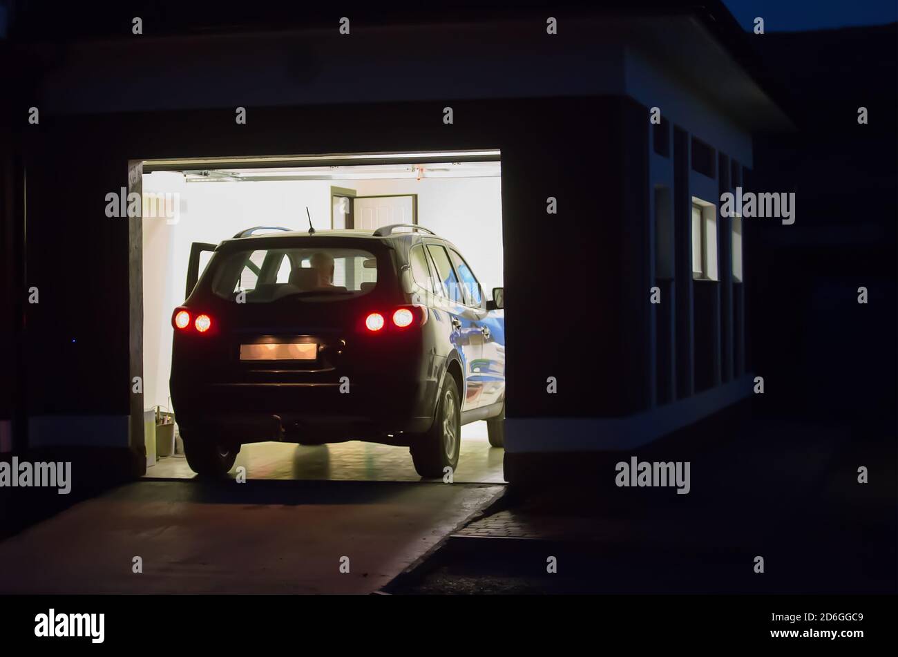 car in a lighted garage at night Stock Photo - Alamy