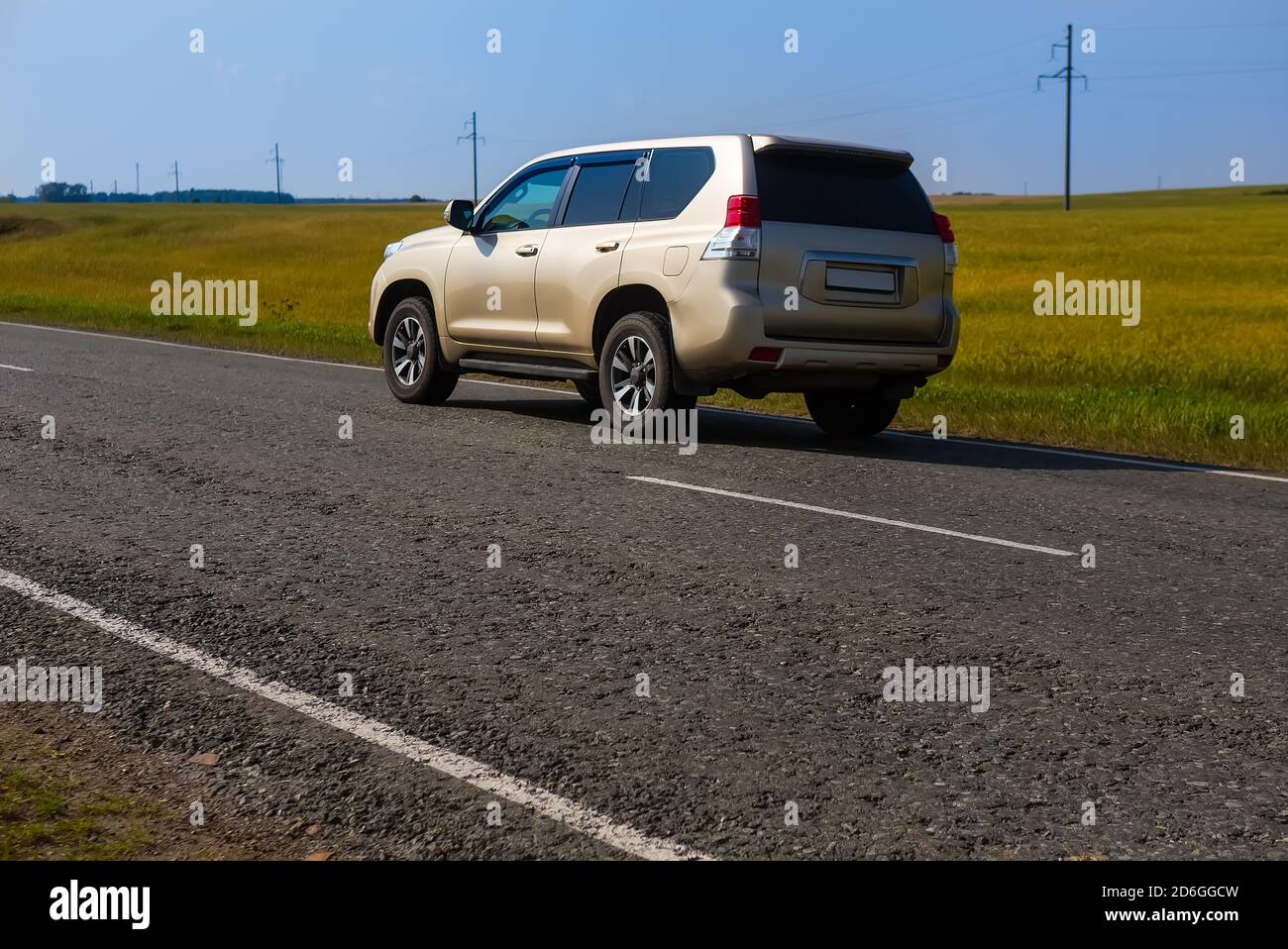 crossover moves along the highway beyond the city in summer Stock Photo ...