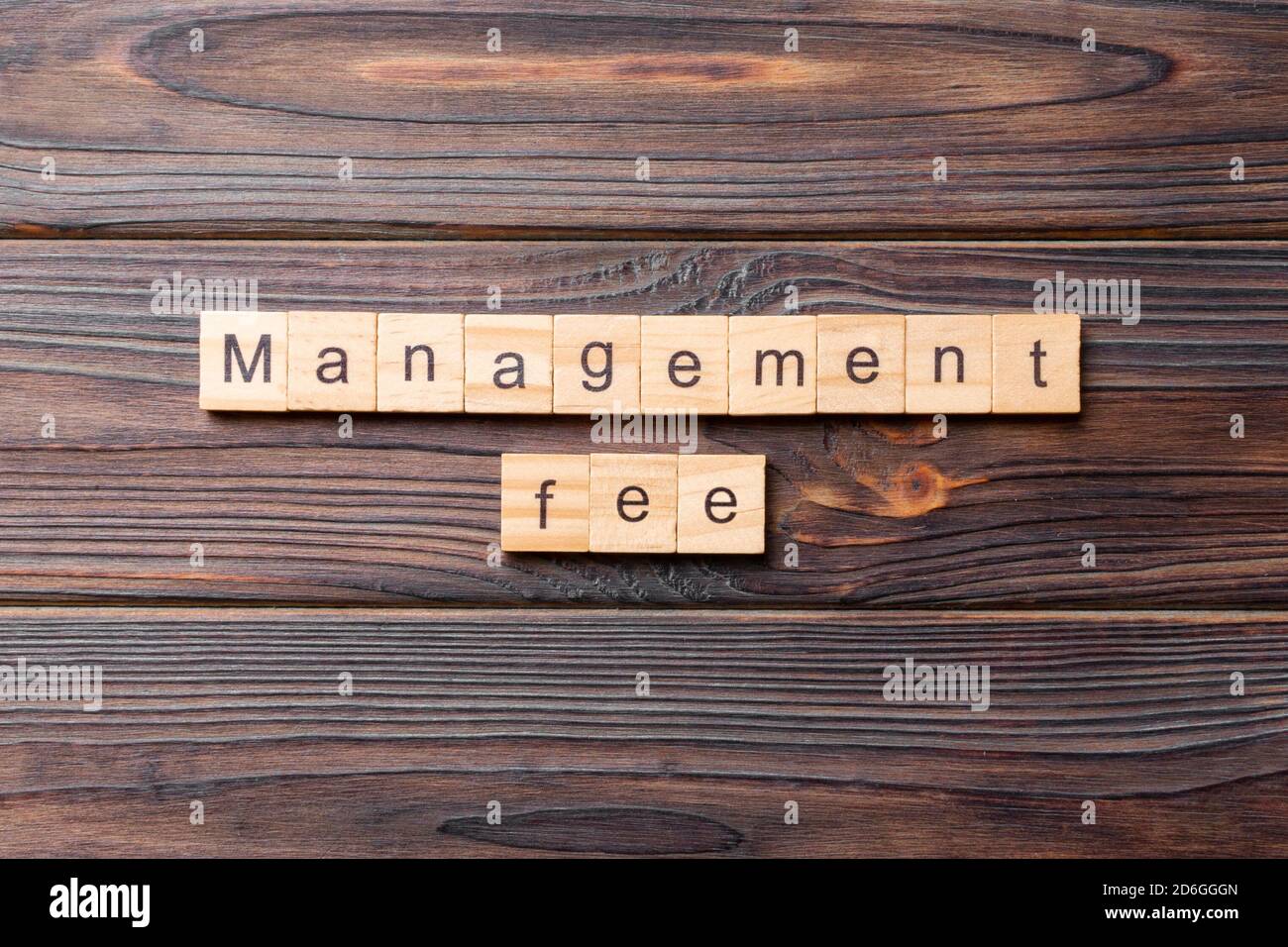 management fee word written on wood block. management fee text on ...