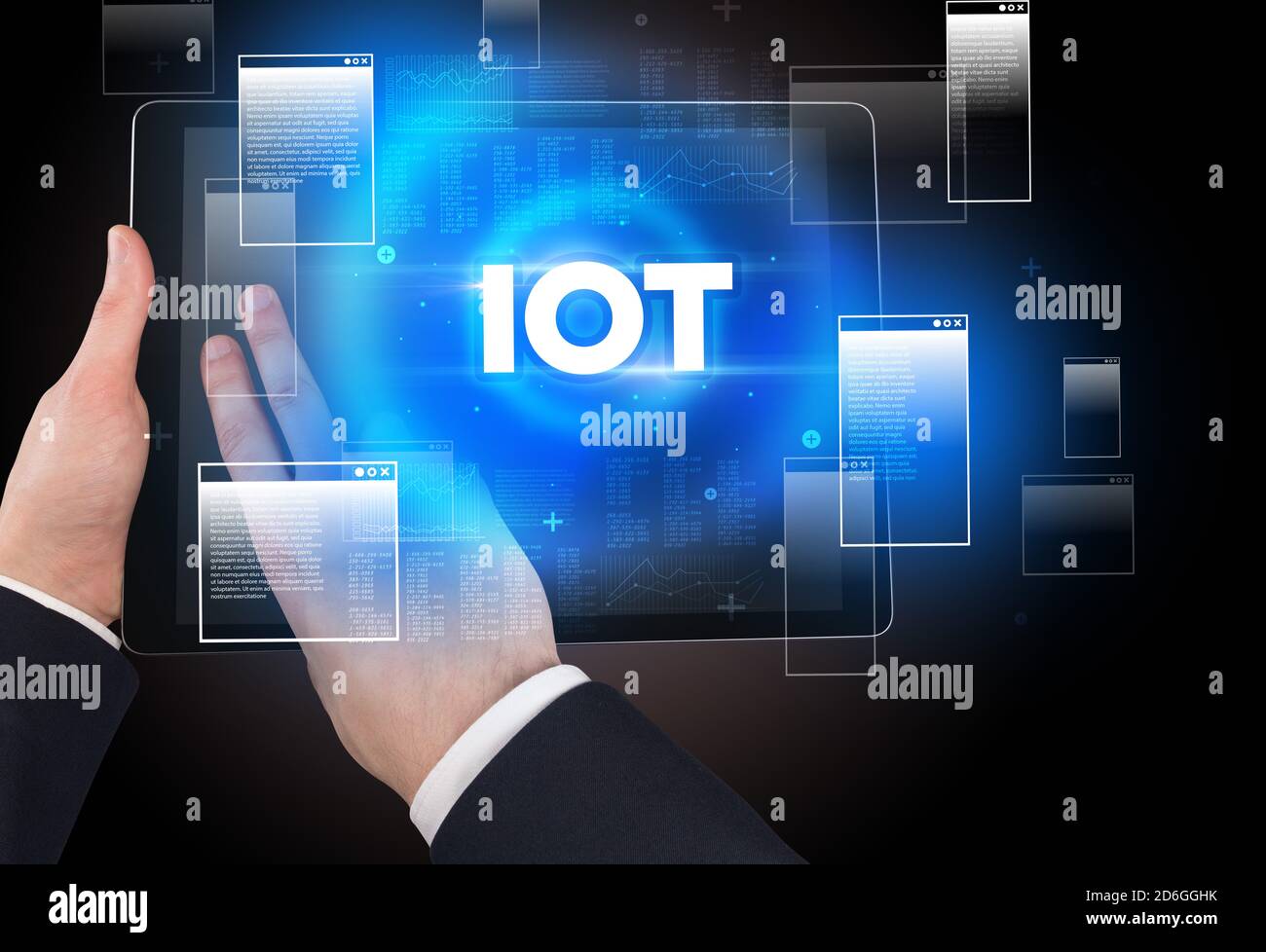 Close-up of a hand holding tablet with IOT abbreviation, modern ...