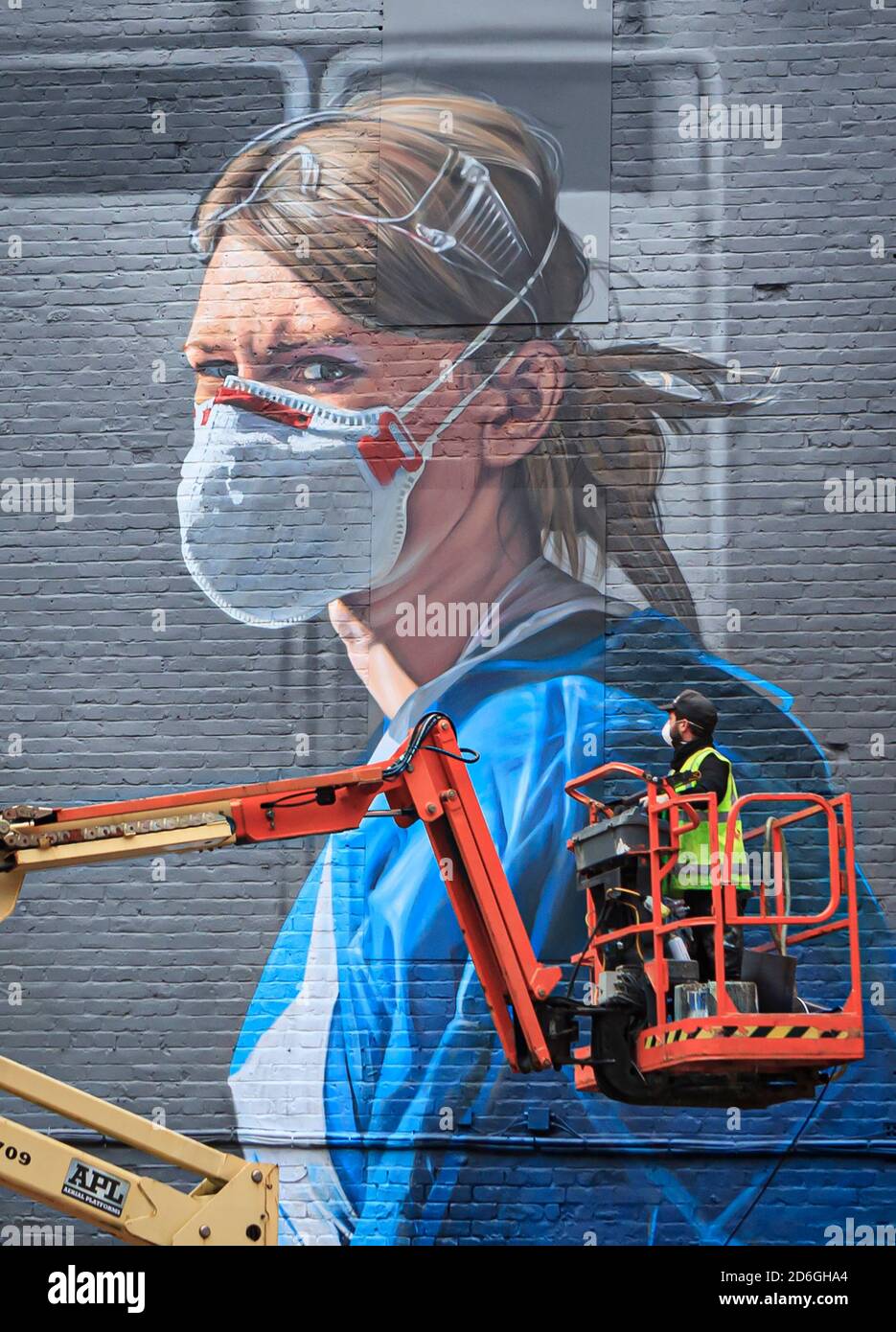Artist Peter Barber works on a mural in Manchester city centre ...