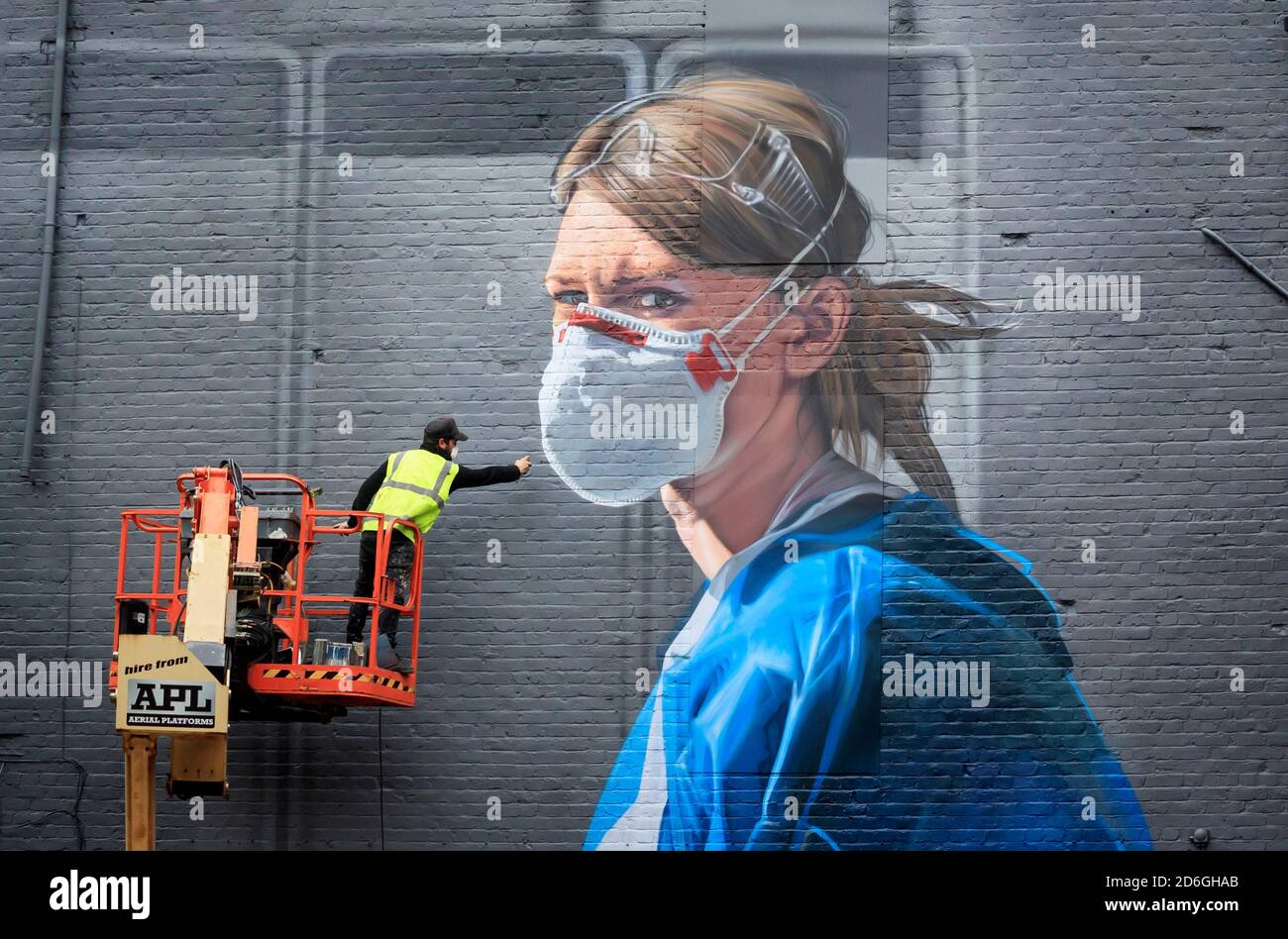 Artist Peter Barber works on a mural in Manchester city centre ...