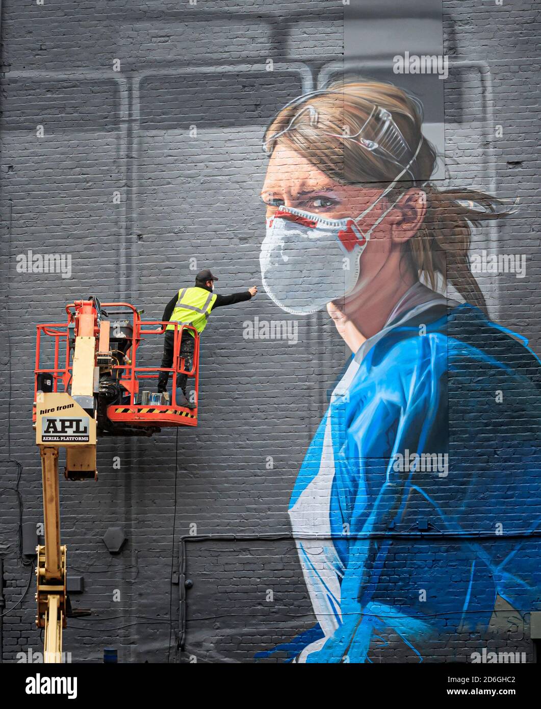 Artist Peter Barber works on a mural in Manchester city centre ...