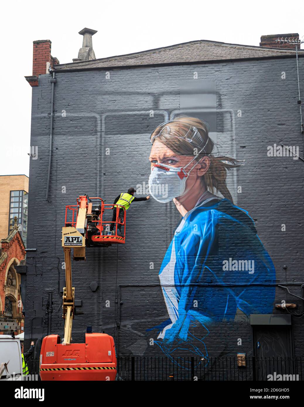 Artist Peter Barber works on a mural in Manchester city centre ...