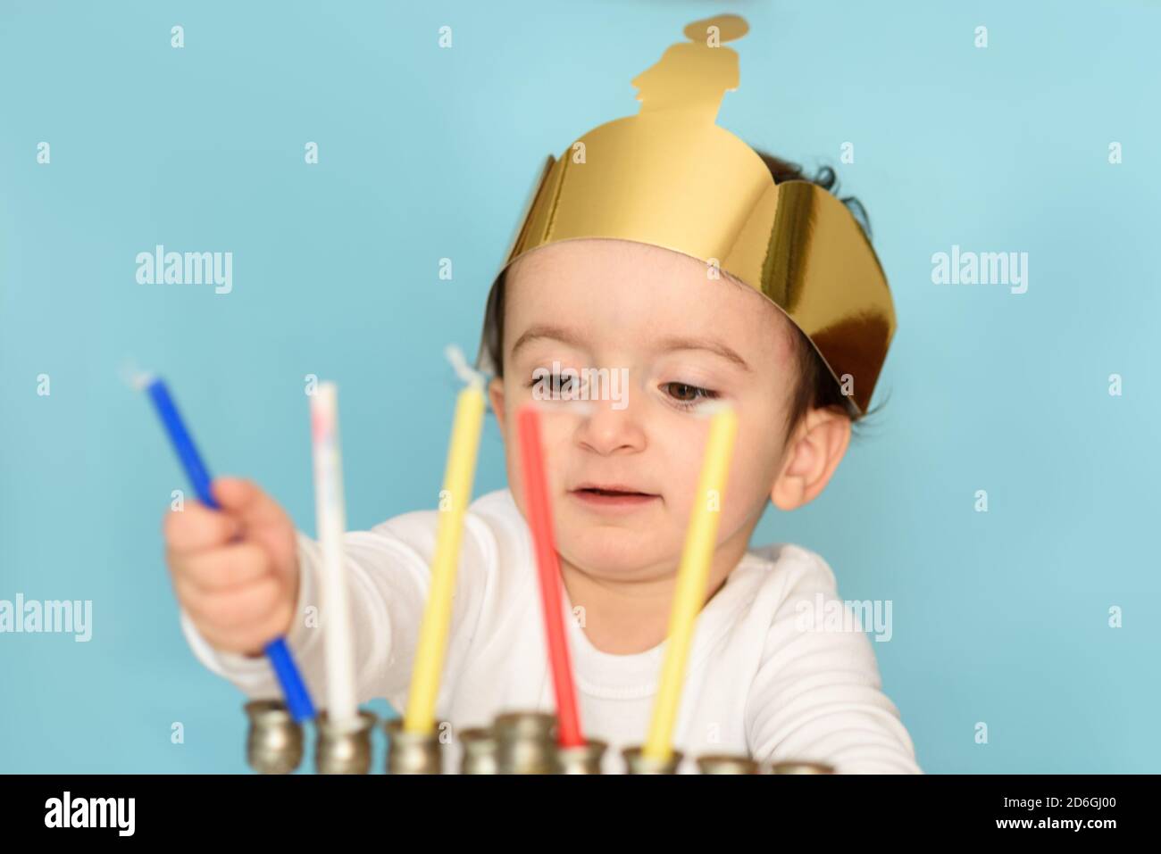 Little jewish boy puts candles on traditional menorah. Child ...