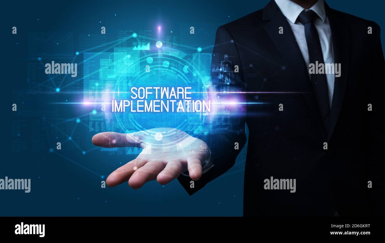Man hand holding SOFTWARE IMPLEMENTATION inscription, technology ...