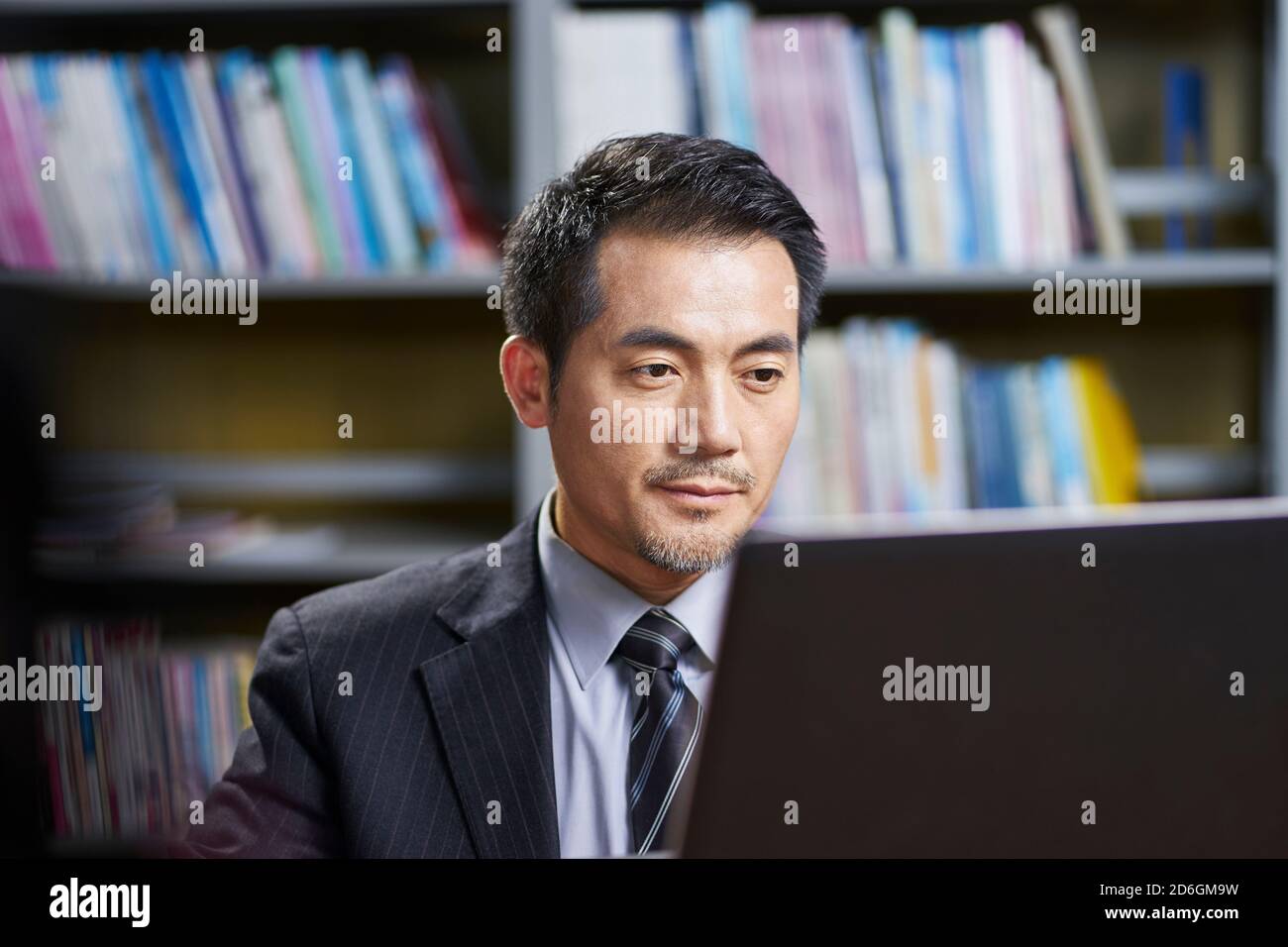 asian corporate executive working in office using laptop computer Stock ...