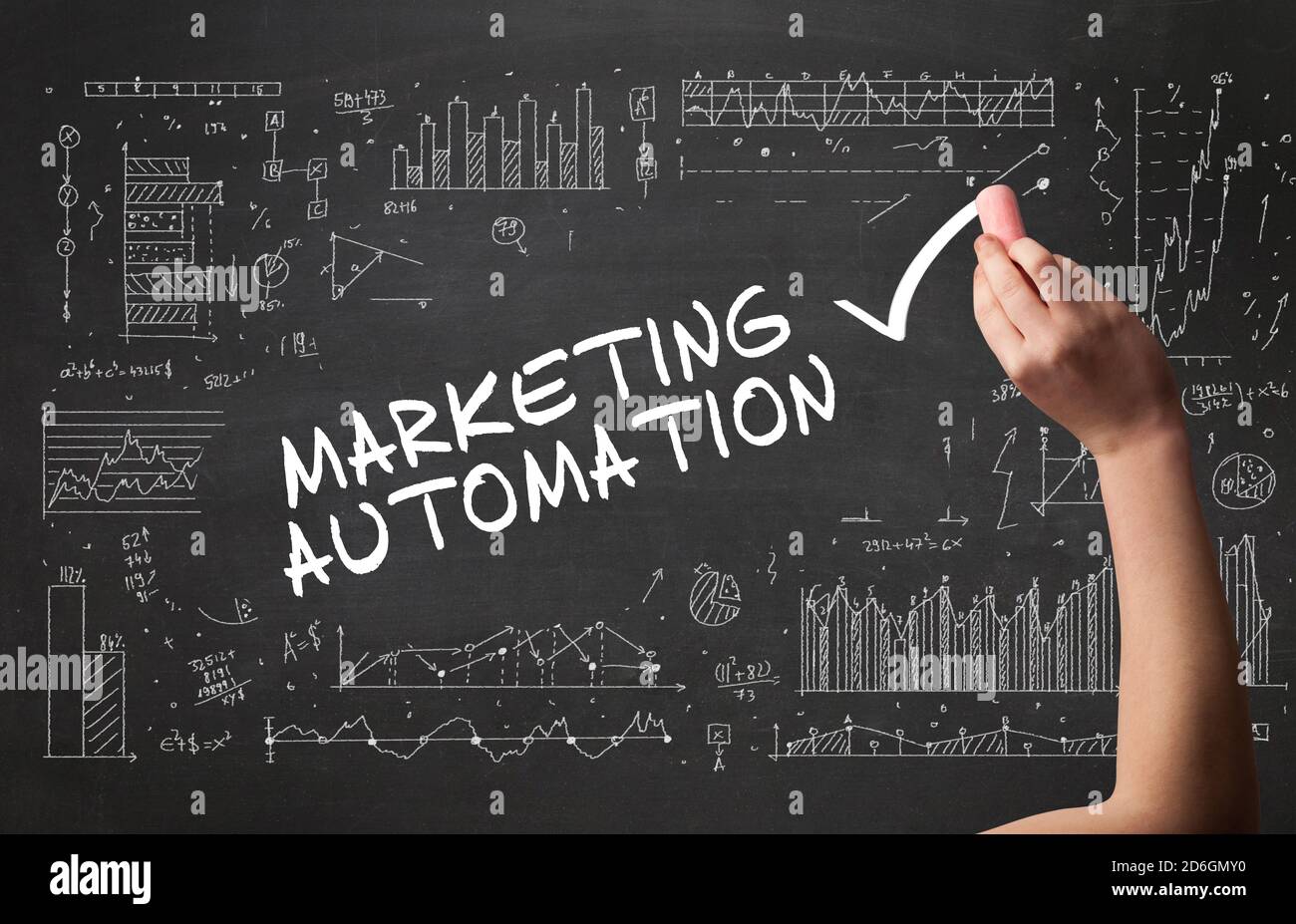 Hand drawing MARKETING AUTOMATION inscription with white chalk on ...