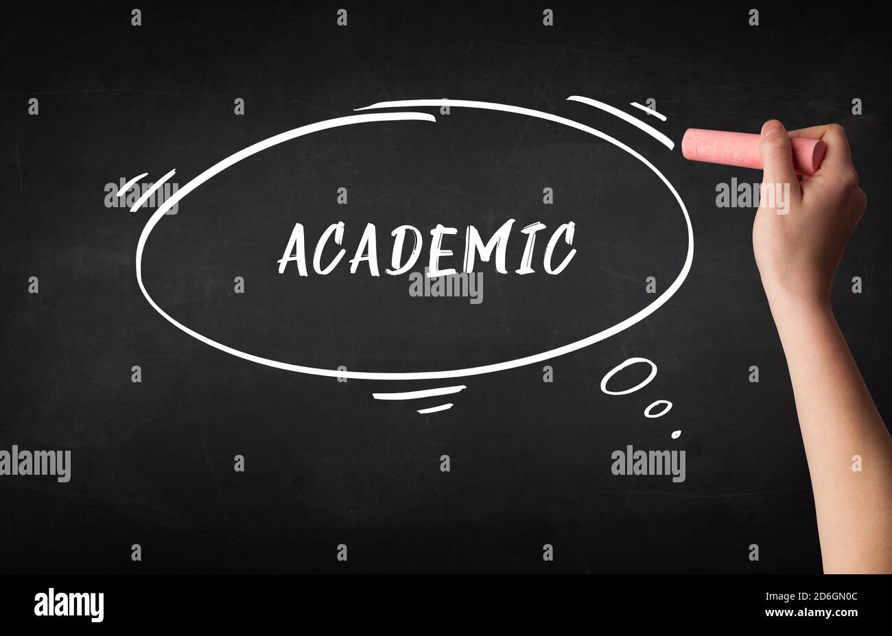 Hand drawing ACADEMIC inscription with white chalk on blackboard ...