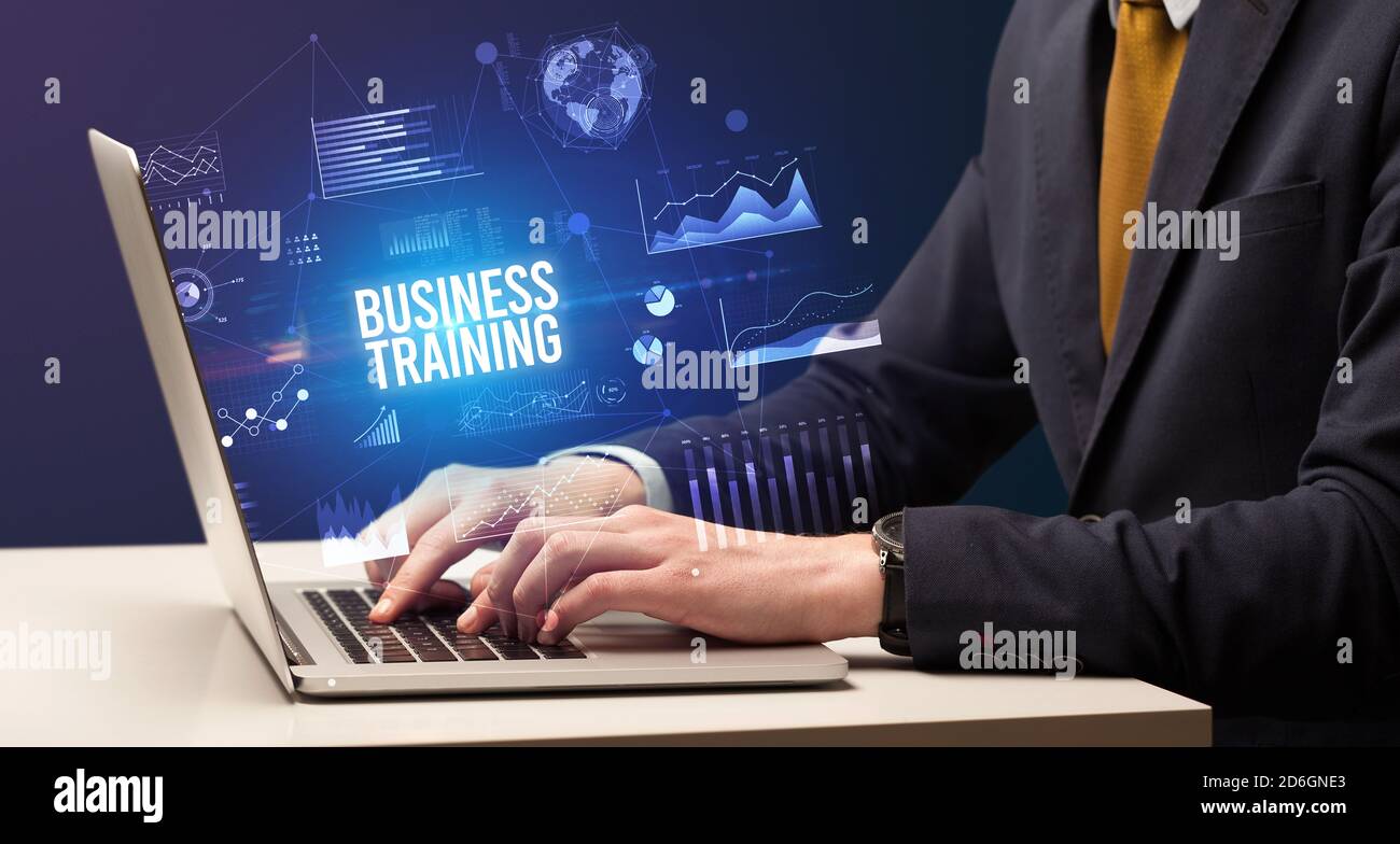 Businessman working on laptop with BUSINESS TRAINING inscription, new ...
