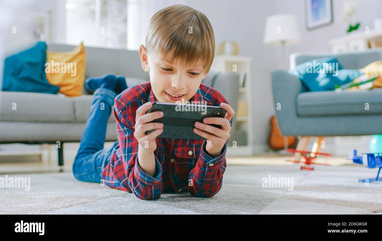 Kid boy child using phone sofa hi-res stock photography and images - Alamy