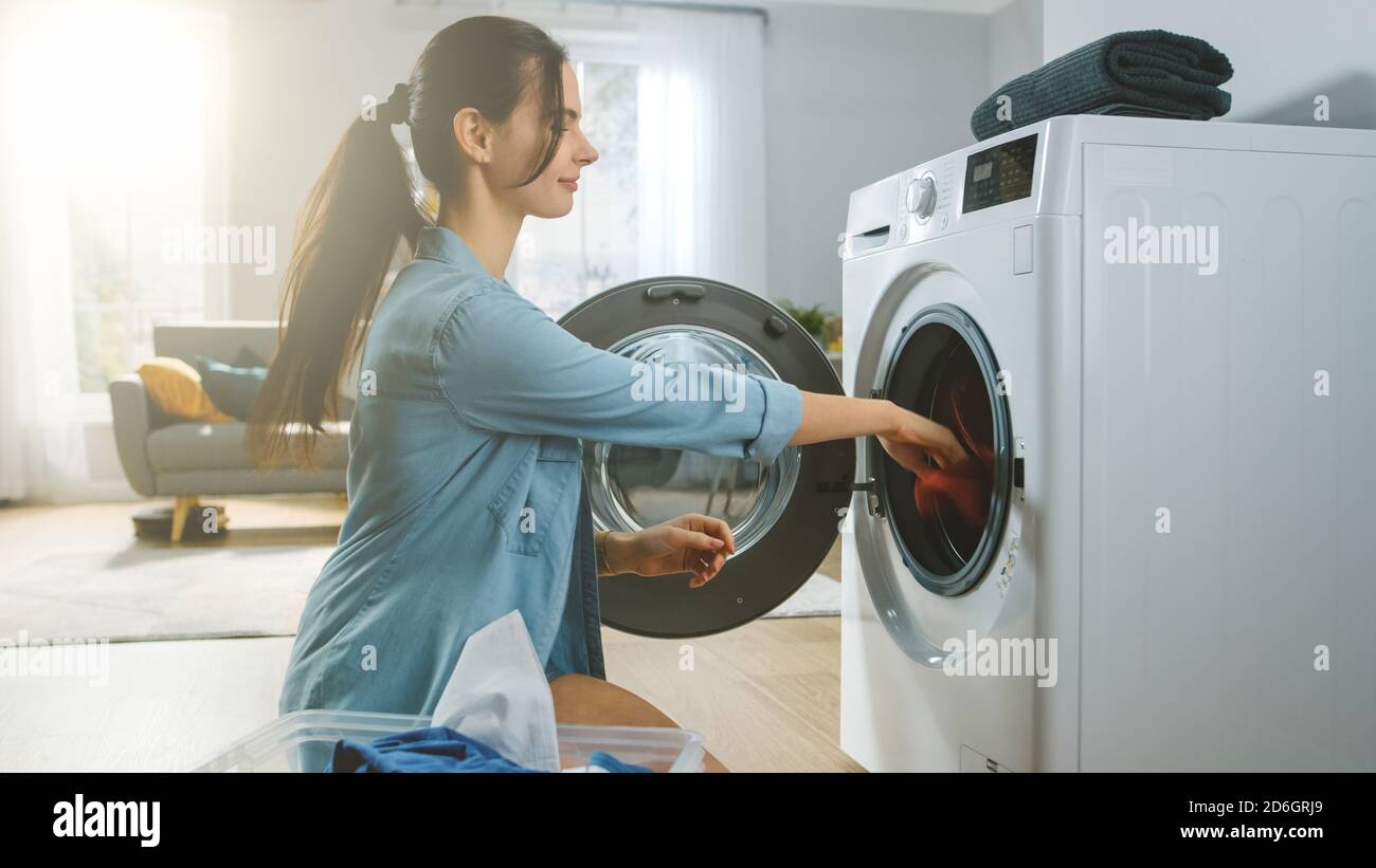 Beautiful Smiling Brunette Young Woman Sits in Front of a Washing ...