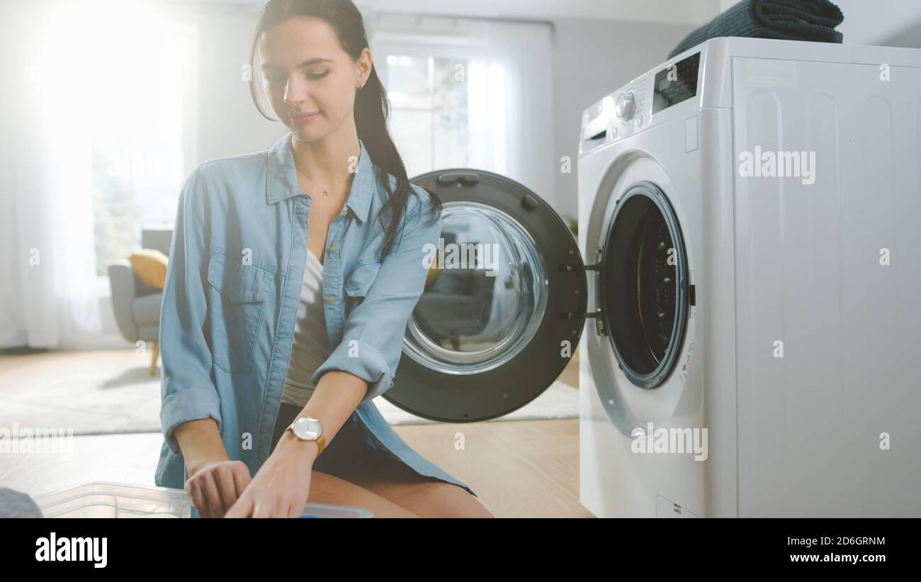 Woman washing her clothes in a laundromat hi-res stock photography and ...
