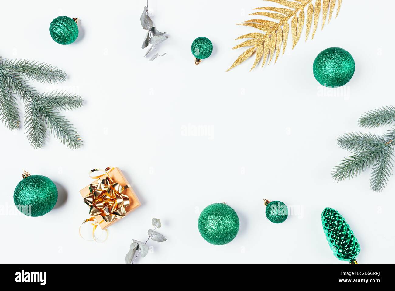 Flat lay Christmas frame with fir tree branches, green baubles and gift ...