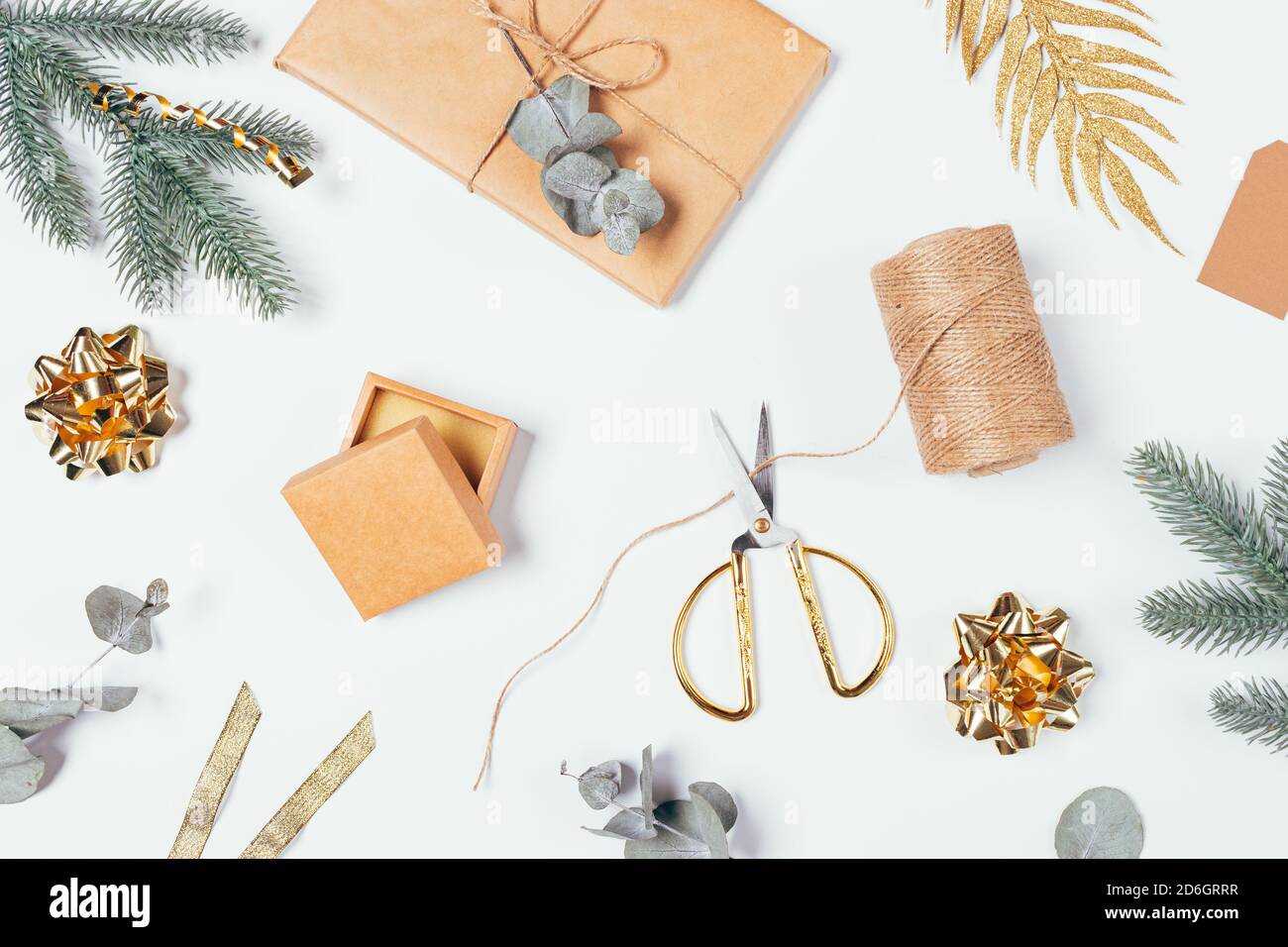 Christmas gift wrapping process on white table with craft brown boxes ...