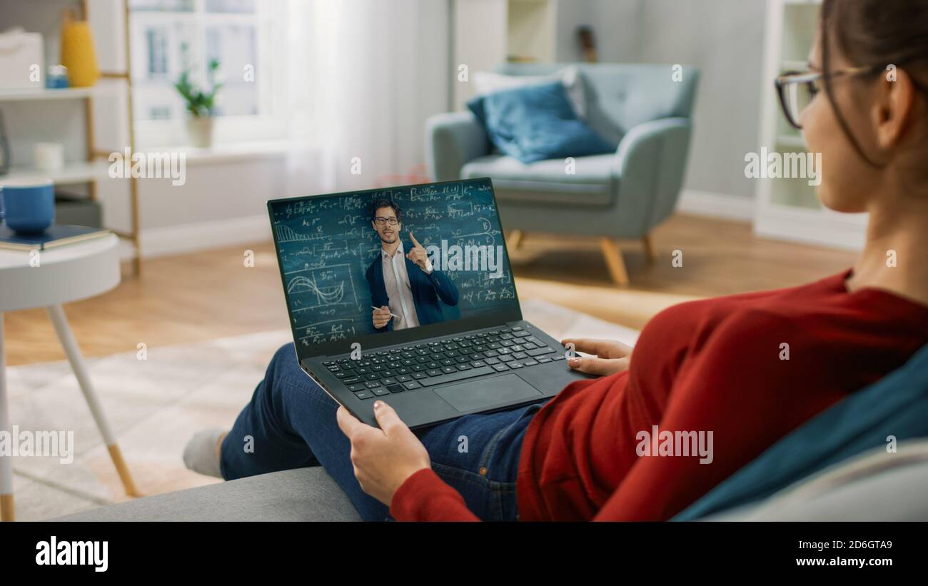Young Woman at Home Uses Laptop for Video Call with His Teacher. Screen ...