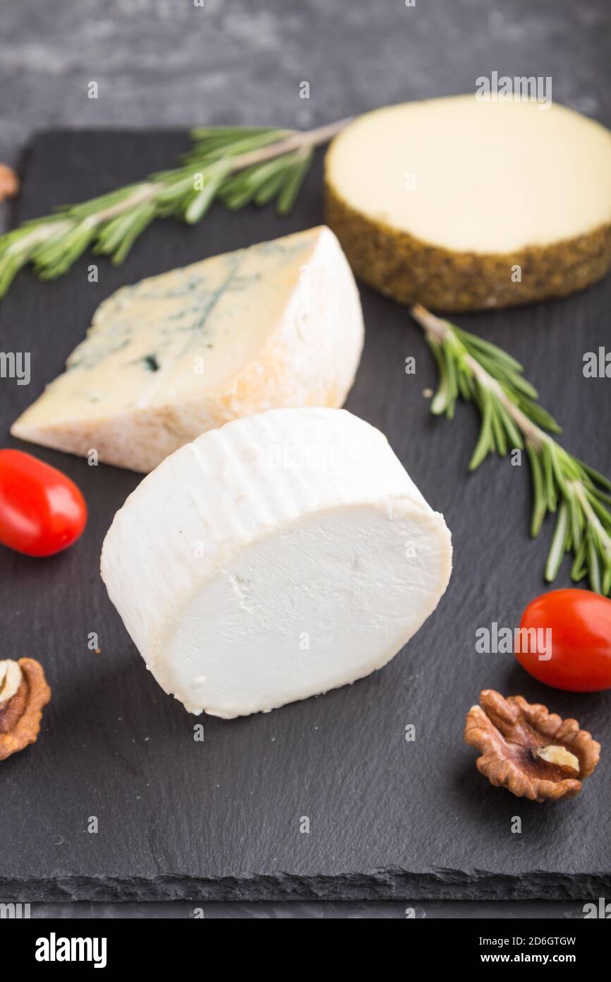 White goat cheese and various types of cheese with rosemary and ...
