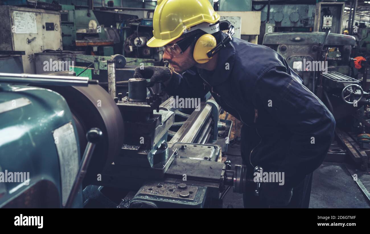 Smart factory worker using machine in factory workshop . Industry and ...