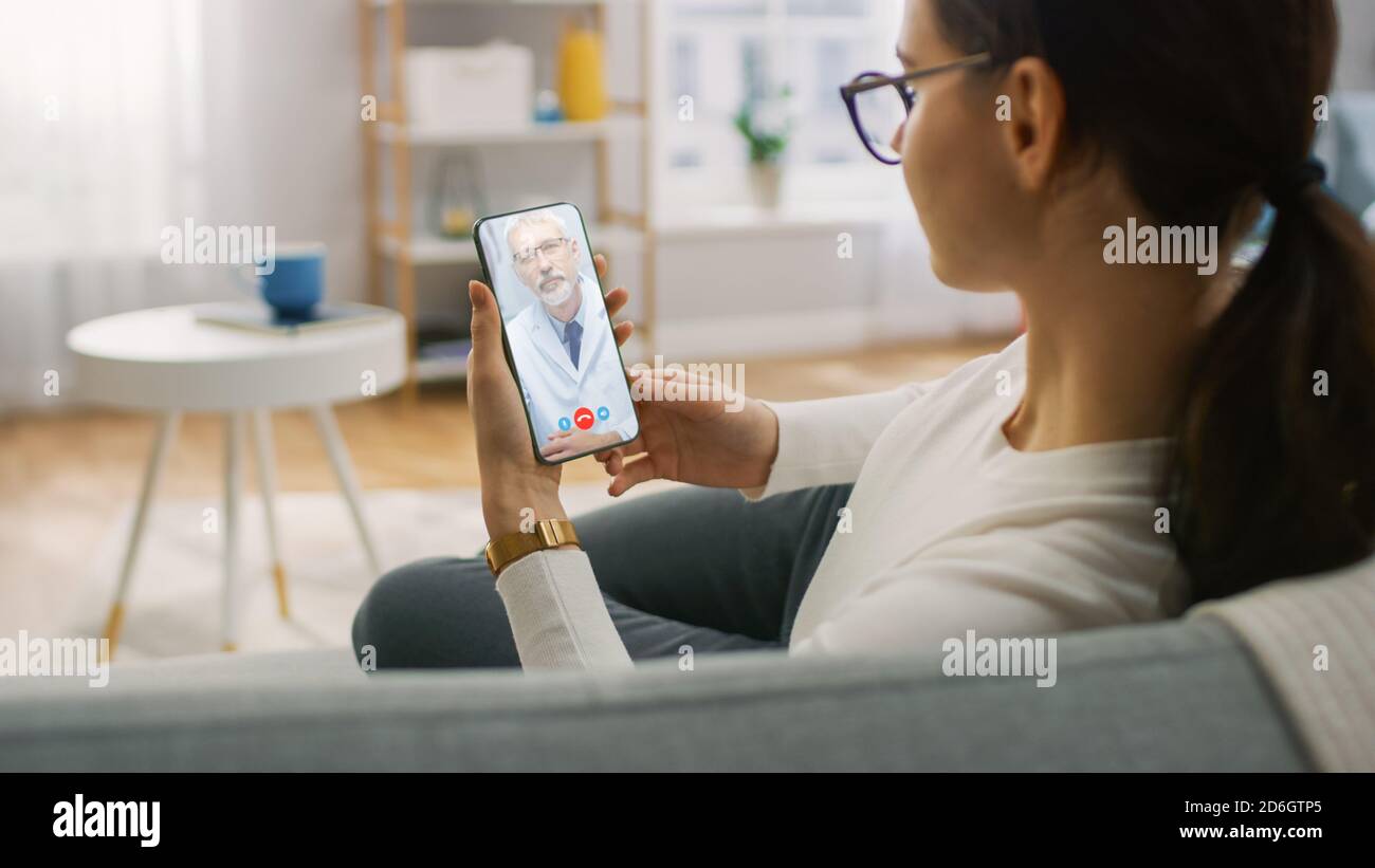 Young Girl Sick at Home Using Smartphone to Talk to Her Doctor via ...