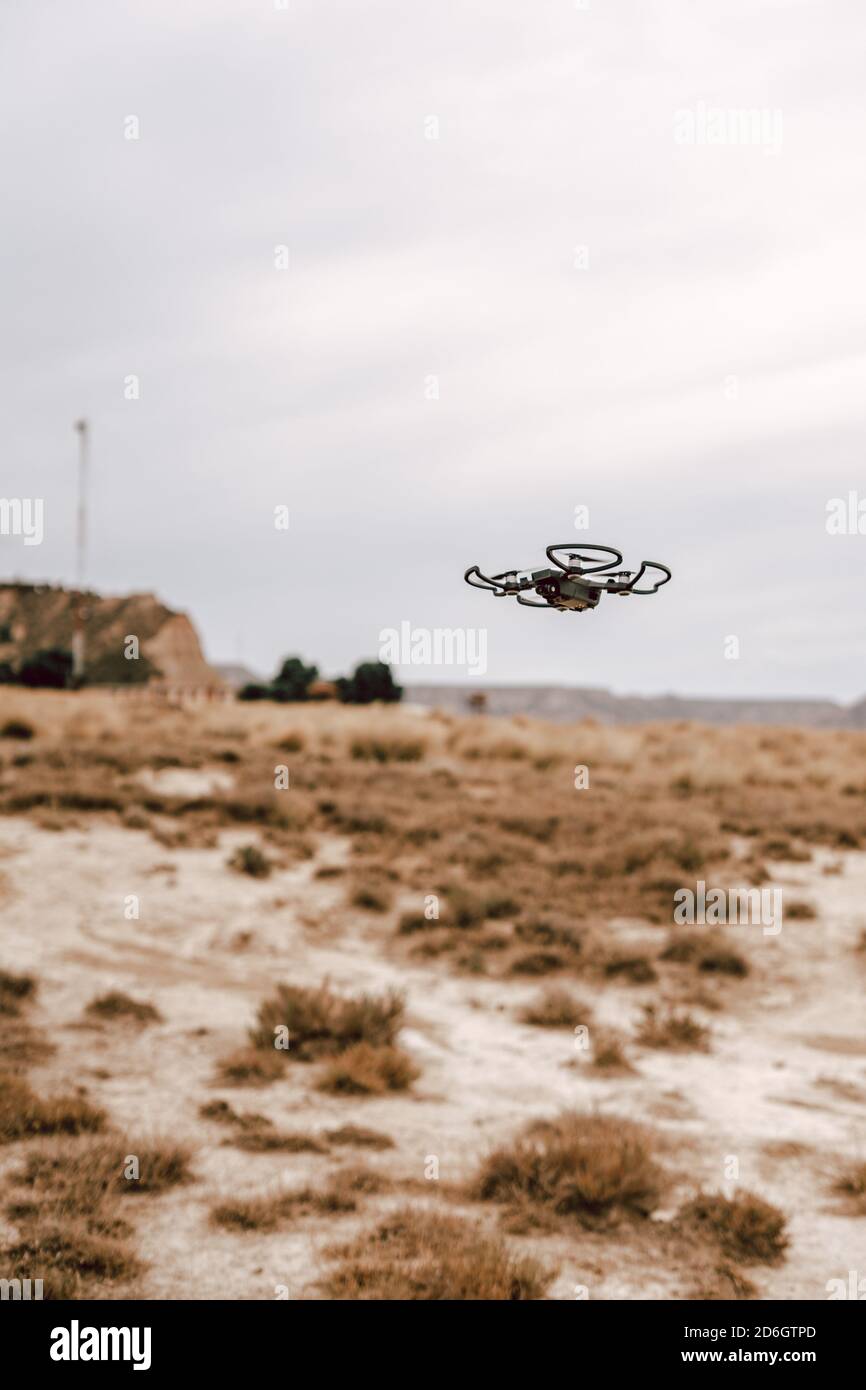 Drone flying over a desertic landscape with dirt and plants Stock Photo ...
