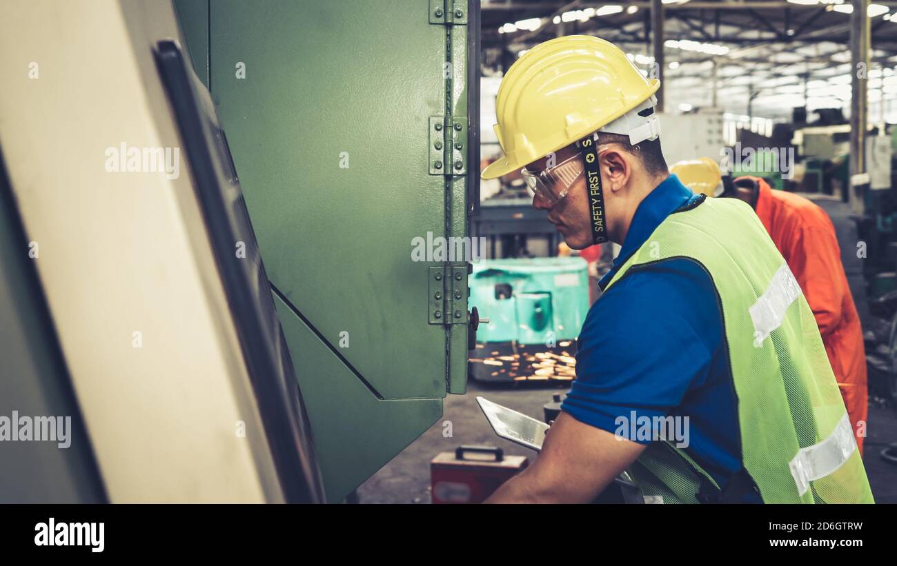 Smart factory worker using machine in factory workshop . Industry and ...