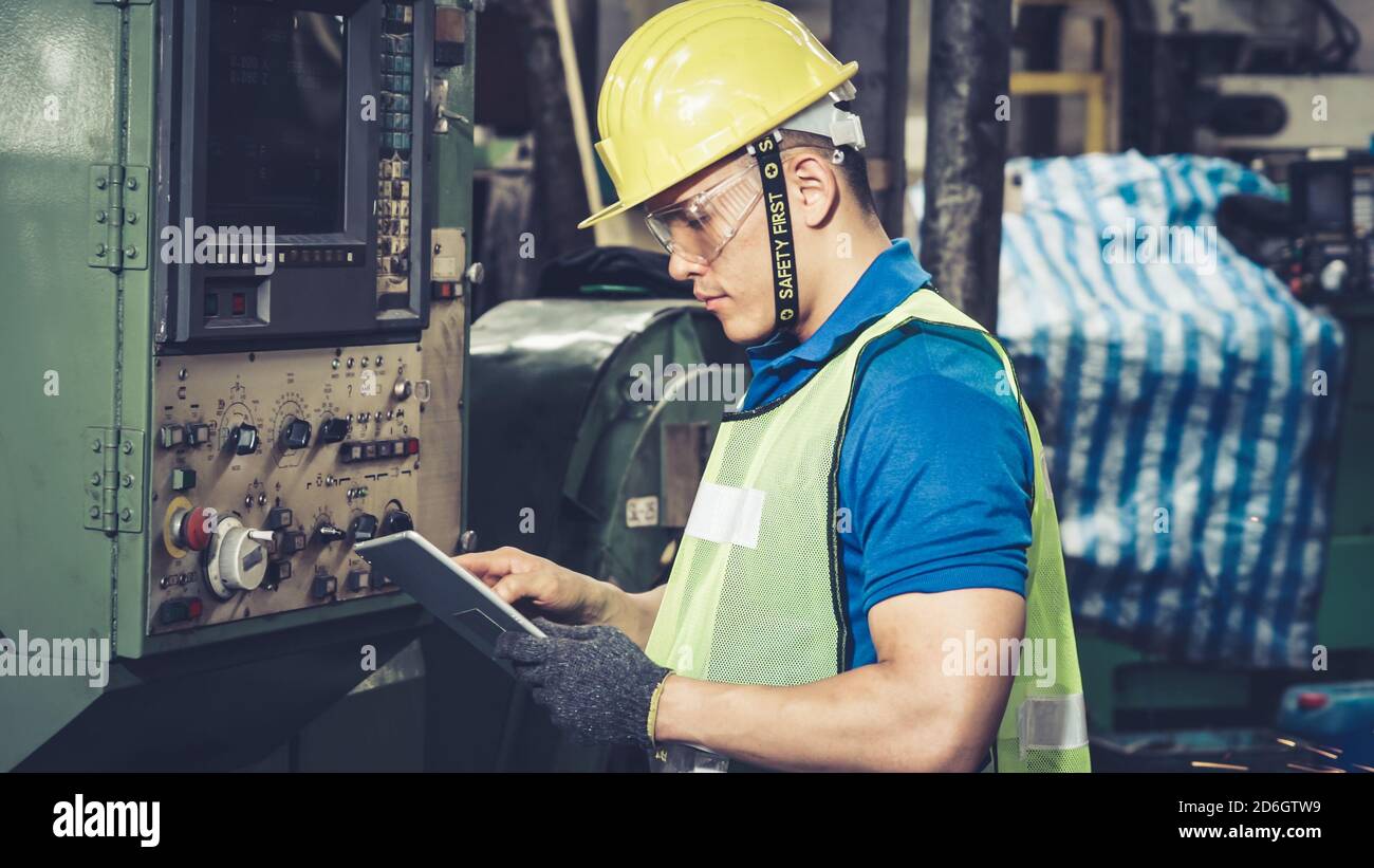 Smart factory worker using machine in factory workshop . Industry and ...