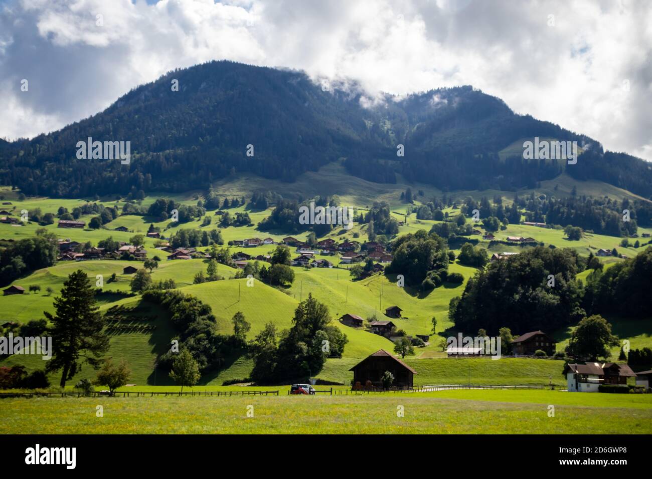 Brown buildings in a small town in the Alps of Switzerland on a summer ...