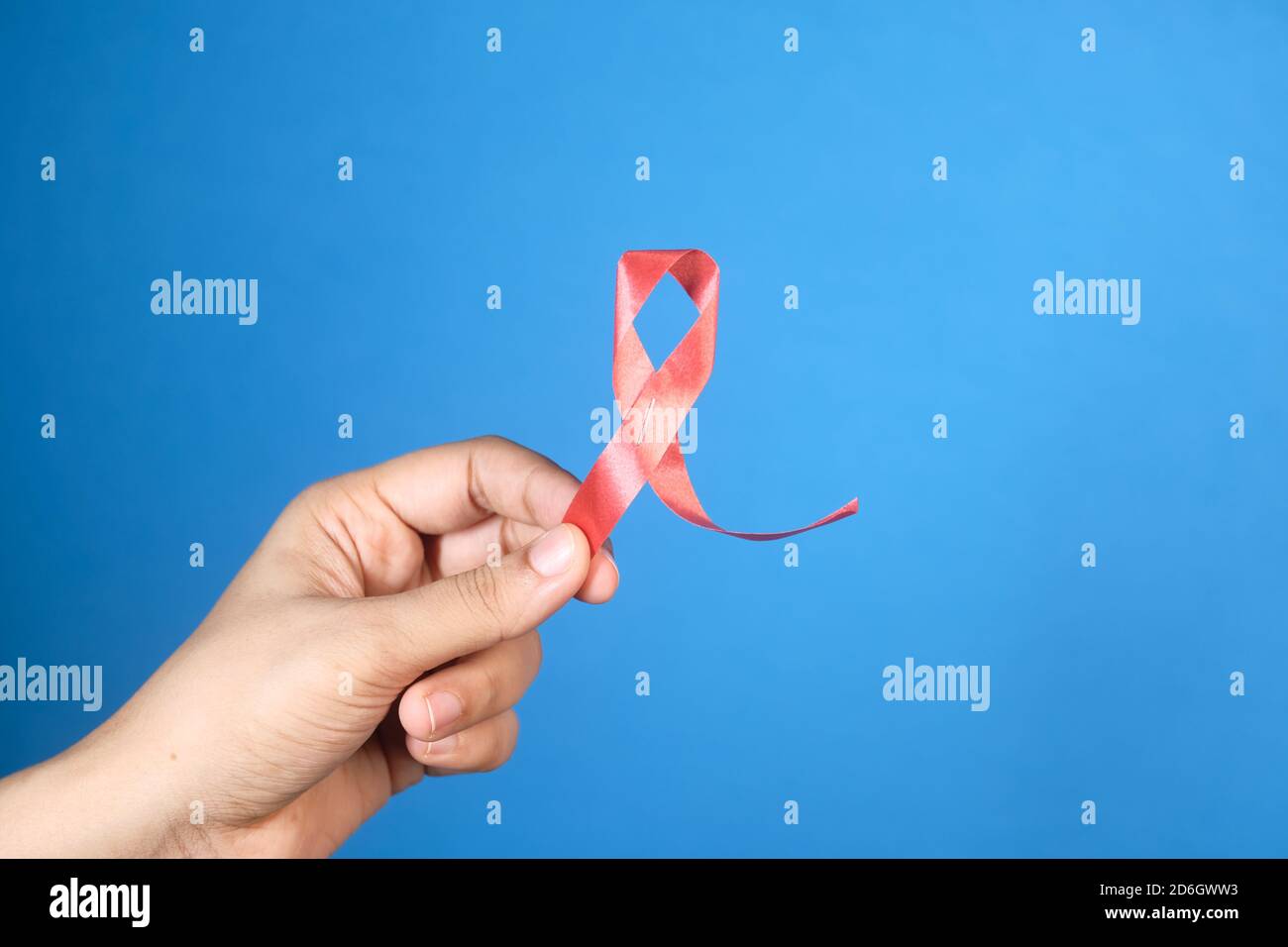 hand holding red HIV ribbon with copy space Stock Photo - Alamy
