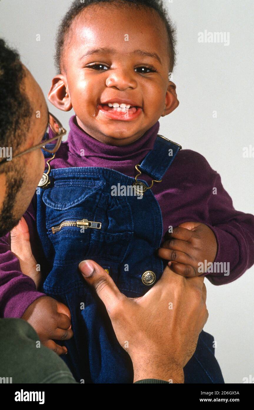 Small African American boy Being Held by His Father, USA Stock Photo ...