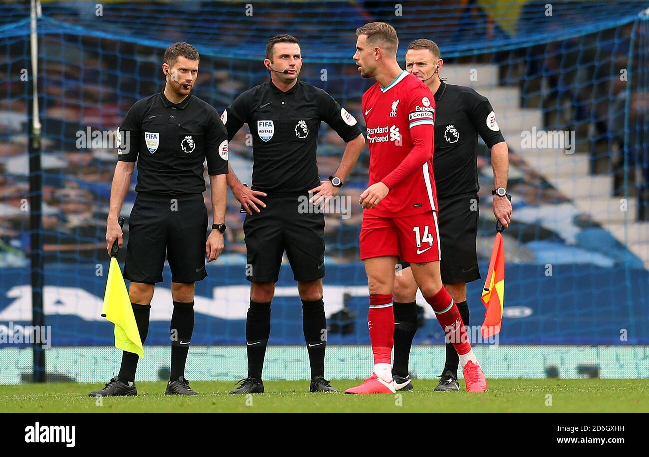 Liverpool's Jordan Henderson speaks to referee Michael Oliver after the ...