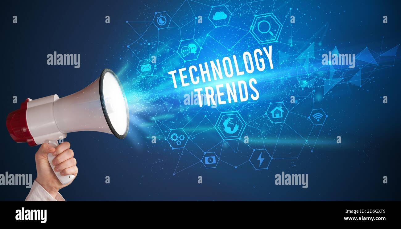 Young woman shouting in megaphone with TECHNOLOGY TRENDS inscription ...