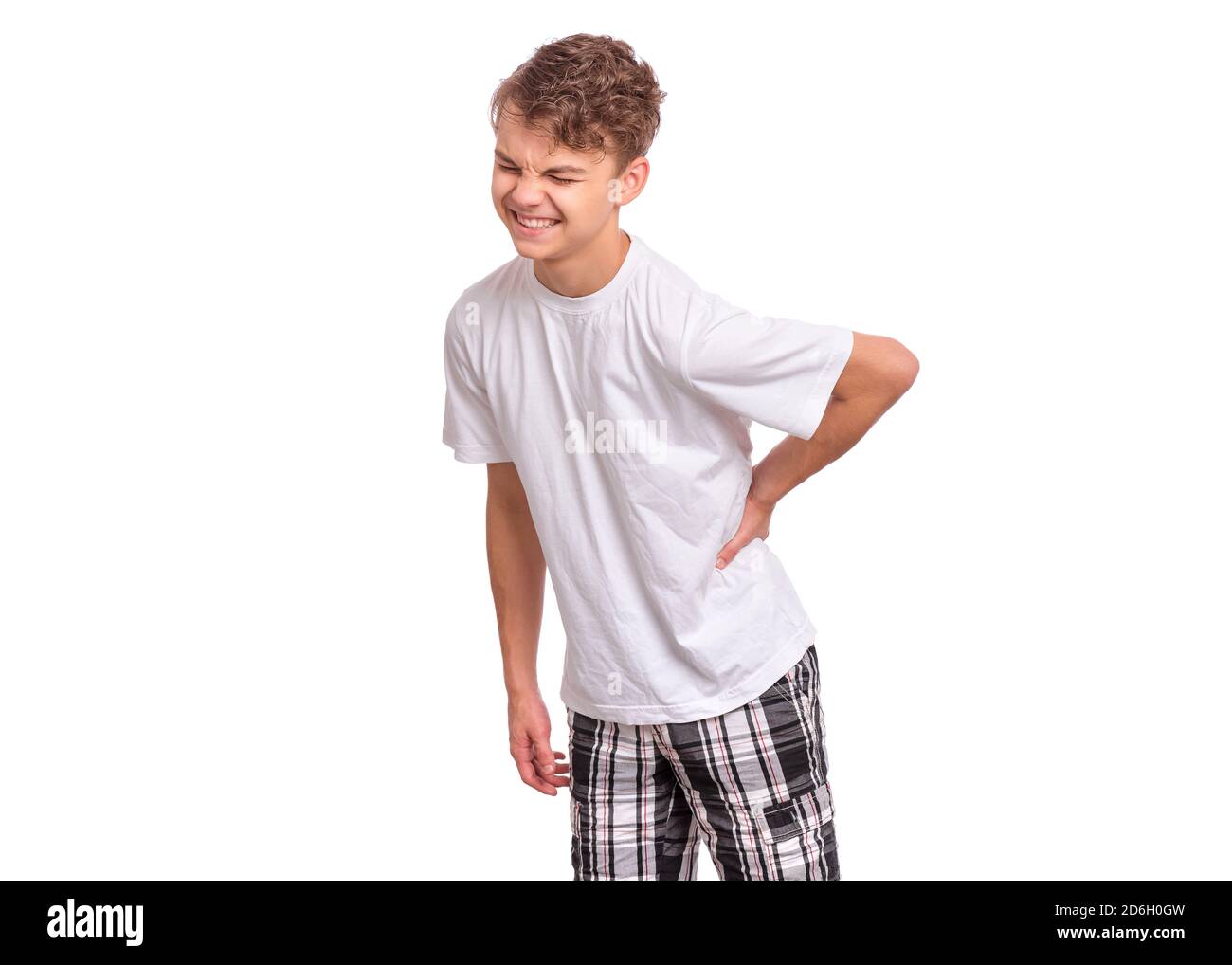 Portrait of unhappy teen boy suffering from backache, isolated on white ...