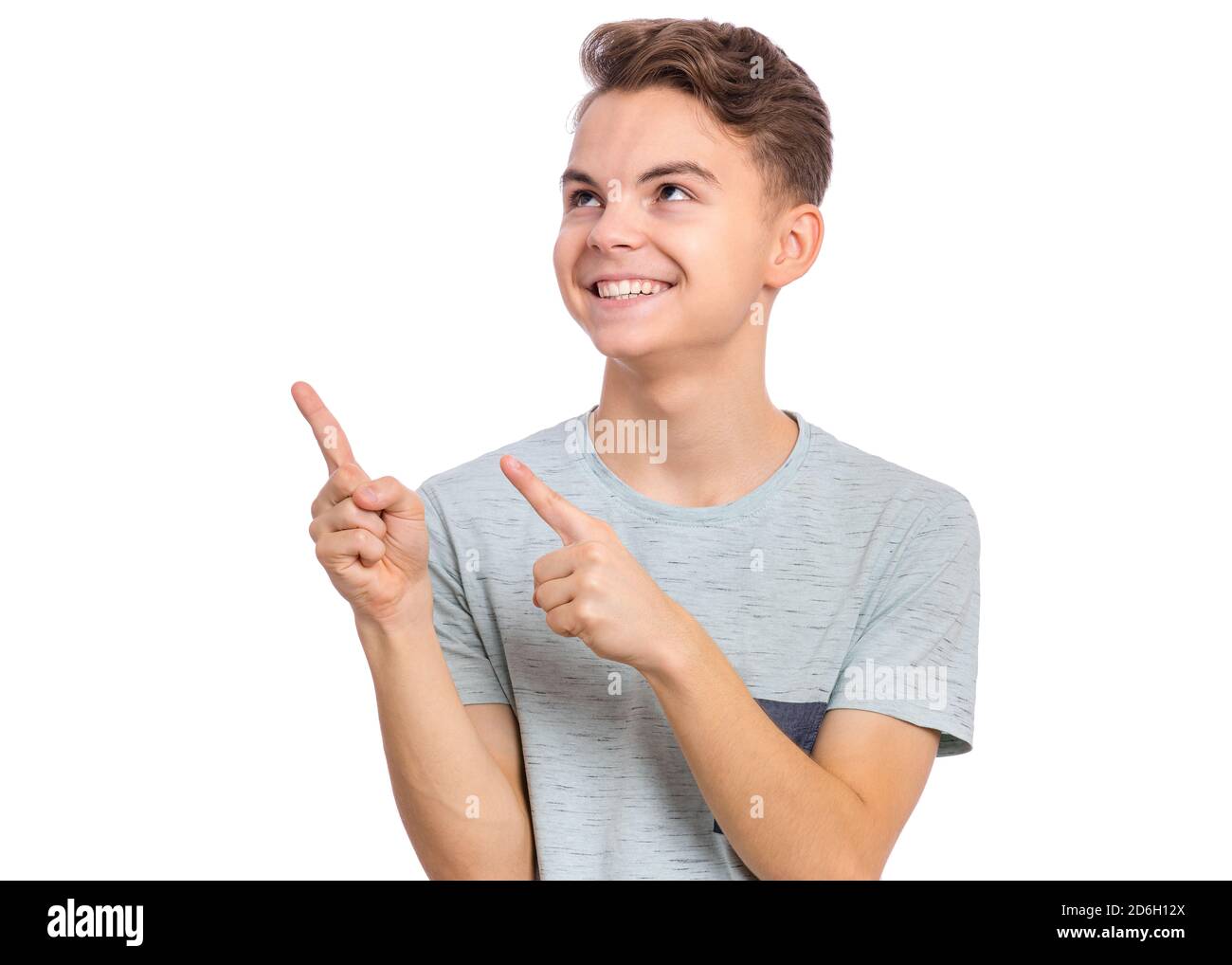 Cute teen boy pointing up, gesturing idea or doing number one gesture ...