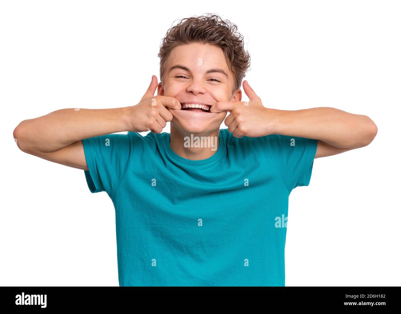 Handsome teen boy showing his to teeth, isolated on white background ...