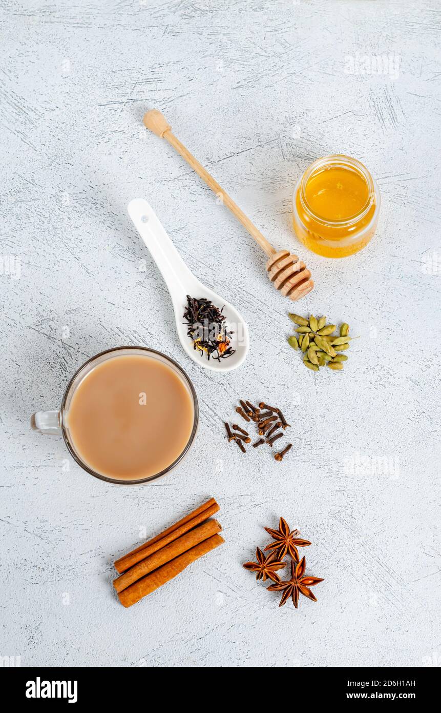 Traditional indian drink masala tea in a glass cup with ingredients for ...