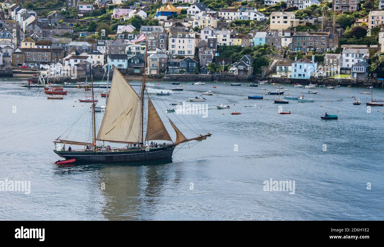 Old ketch leaving Fowey Harbour with Poltuan town behind Cornwall ...
