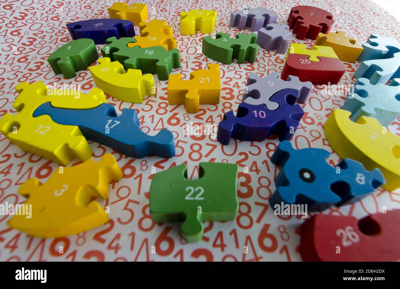 Closeup of colorful children's puzzles on a surface with numbers on it ...