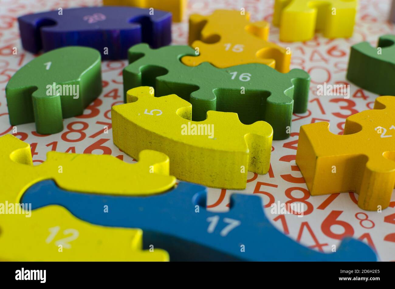Closeup of colorful children's puzzles on a surface with numbers on it ...