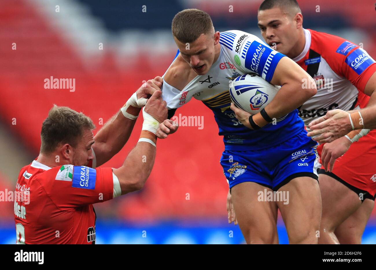 Leeds Rhinos' Ash Handley (right) is tackled by Salford Red Devils Lee ...