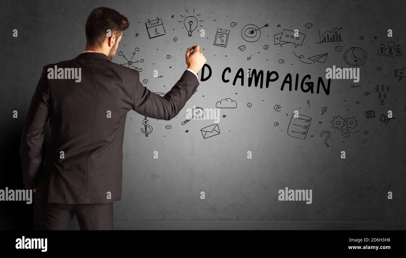 businessman drawing a creative idea sketch with AD CAMPAIGN inscription ...
