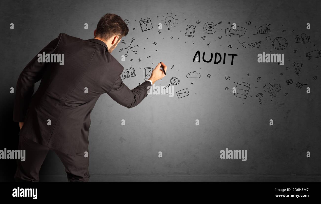 businessman drawing a creative idea sketch with AUDIT inscription ...
